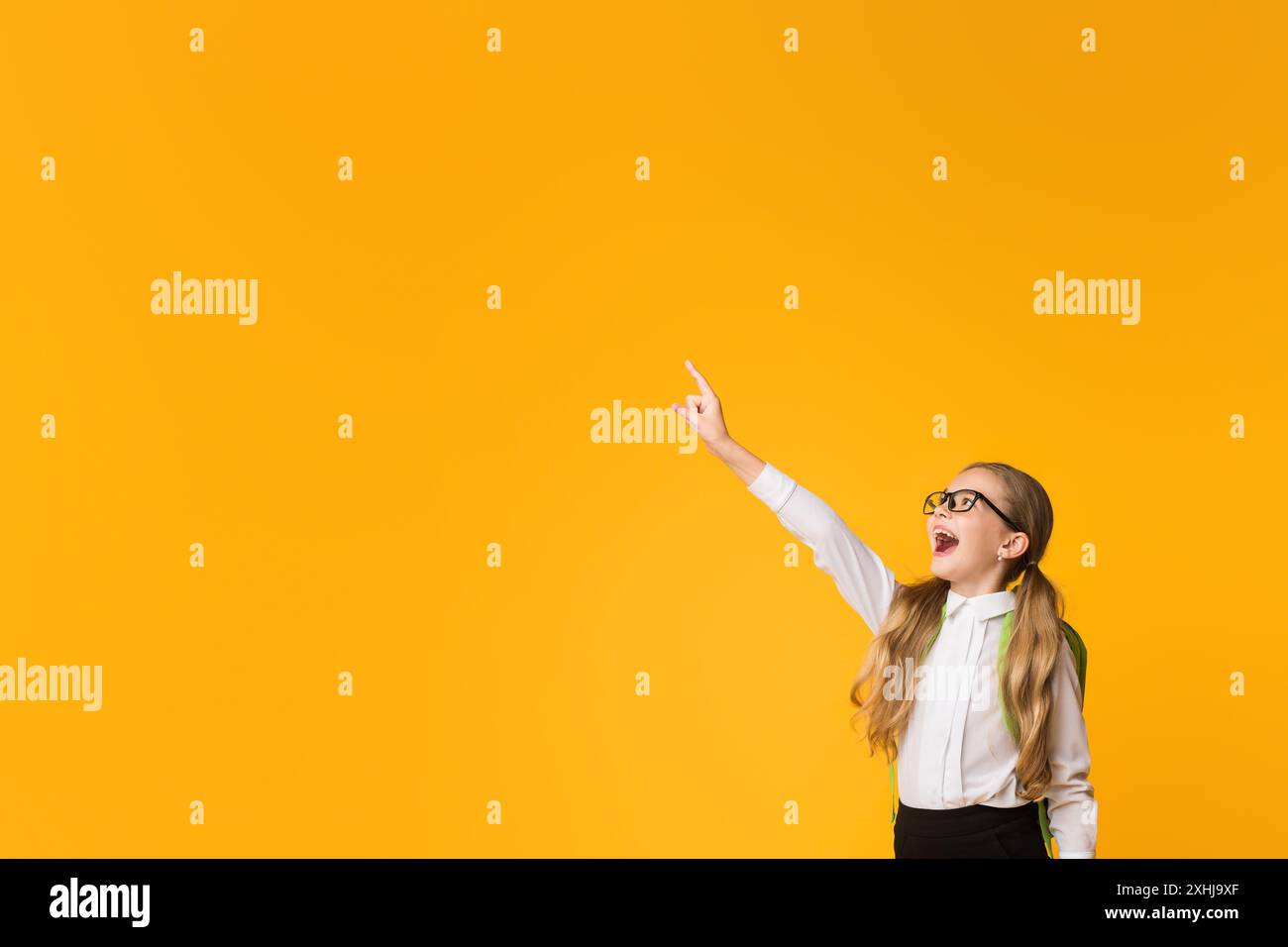 Elementary School Girl Pointing Finger Posing Over Yellow Studio ...
