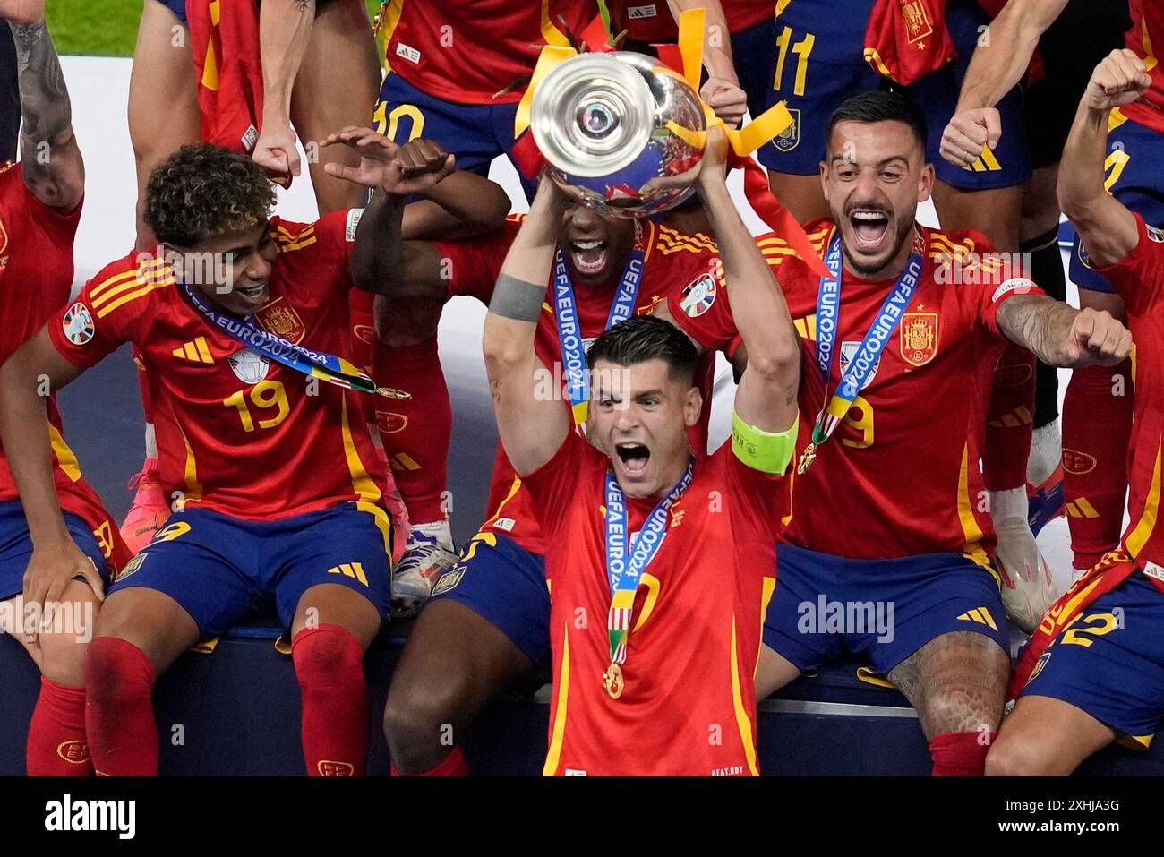 Spain's Alvaro Morata lifts the trophy after winning the final match ...