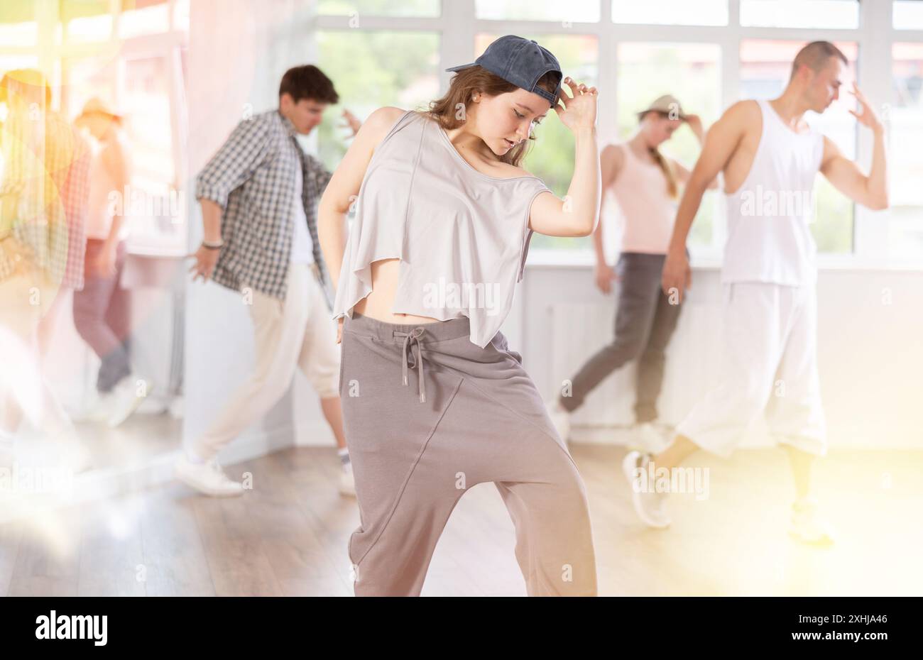 Young girl practicing hip hop slide moves in training hall Stock Photo ...
