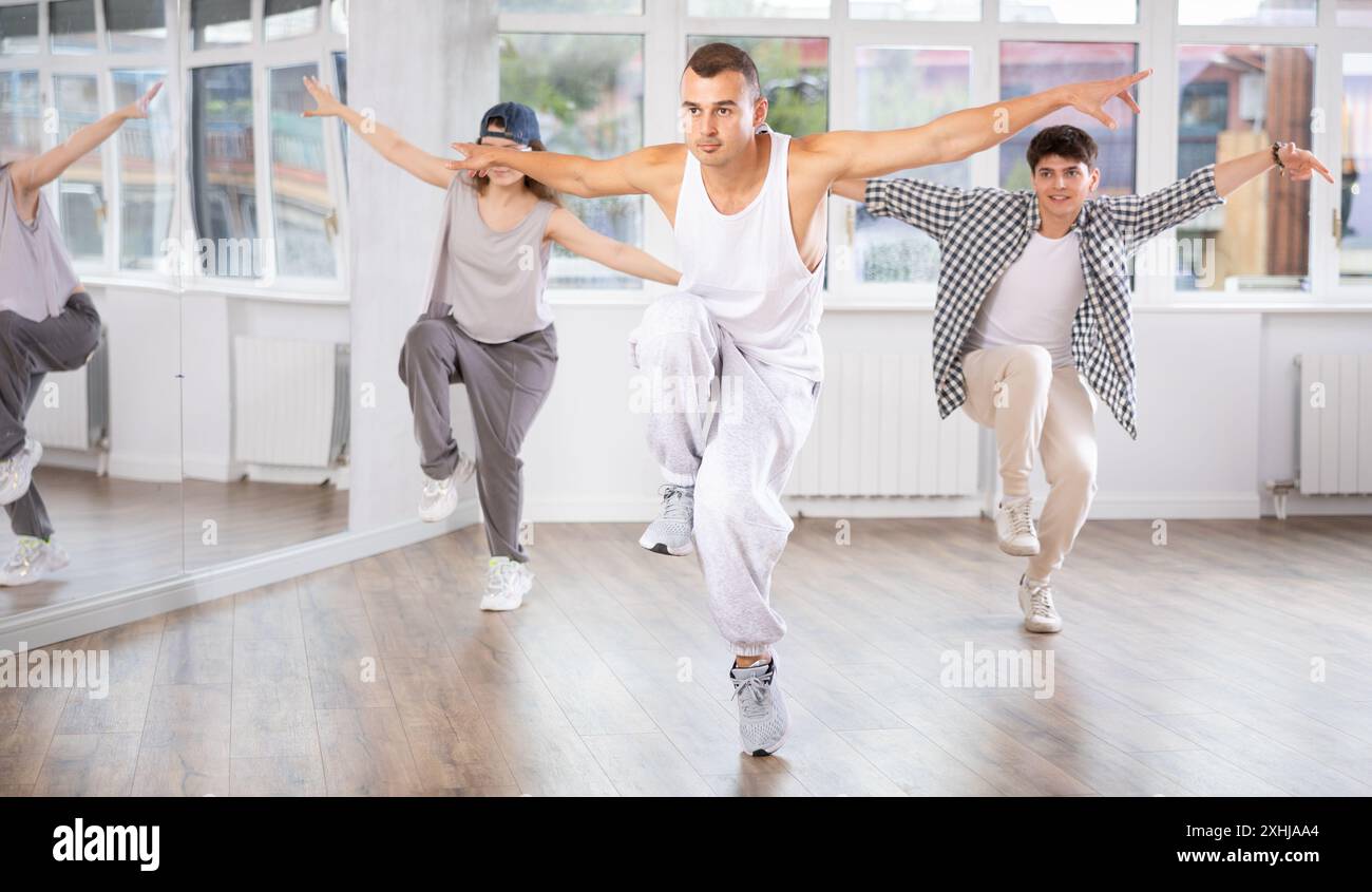 Young guy practicing hip hop reject step in training hall Stock Photo ...