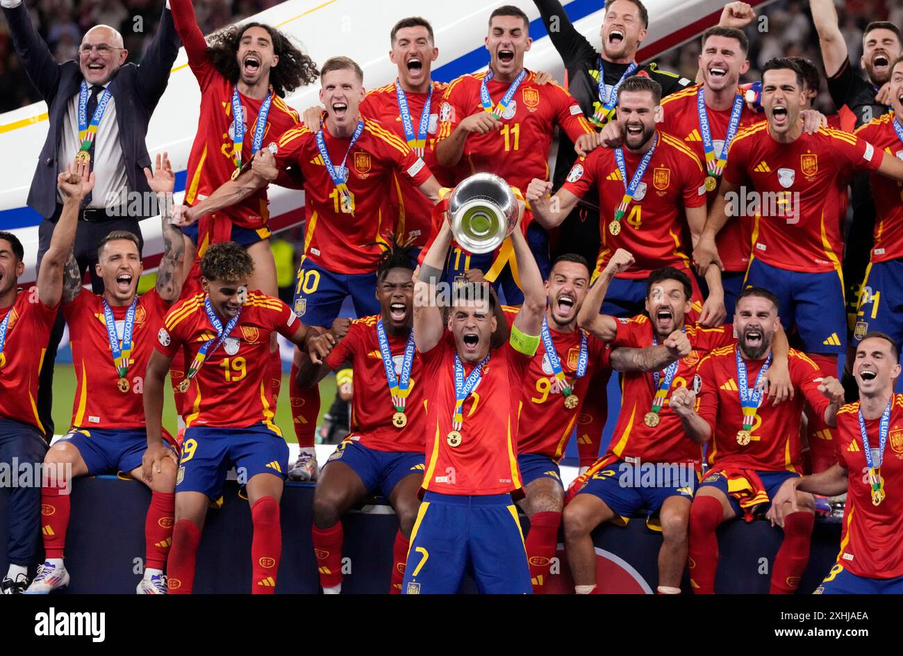 Spain's Alvaro Morata holds the trophy as he celebrates with his ...
