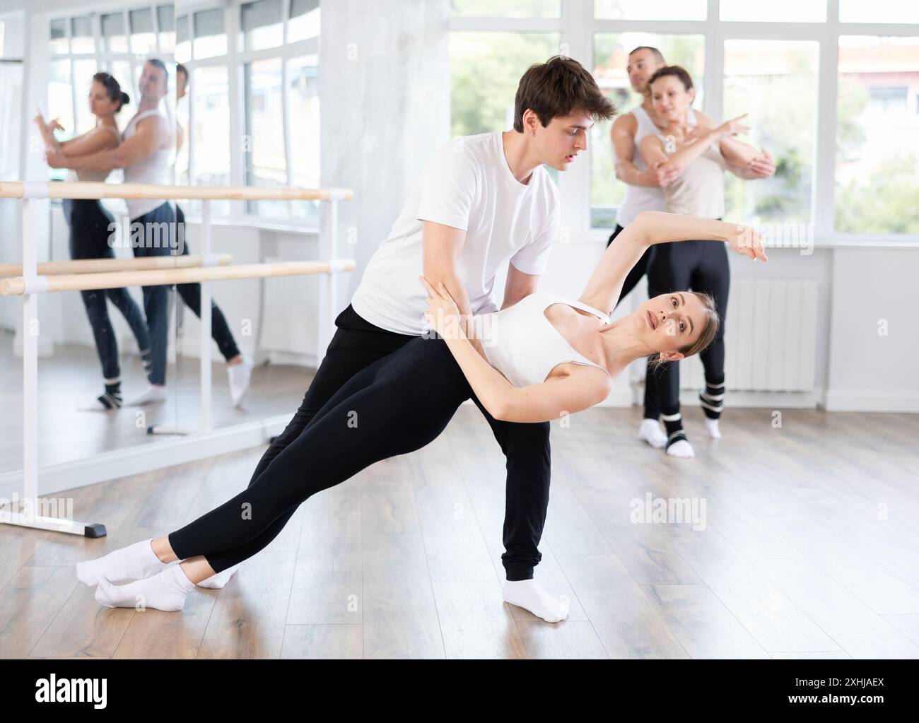 Diligent couple of athletic modern ballet dancers practicing ballet ...