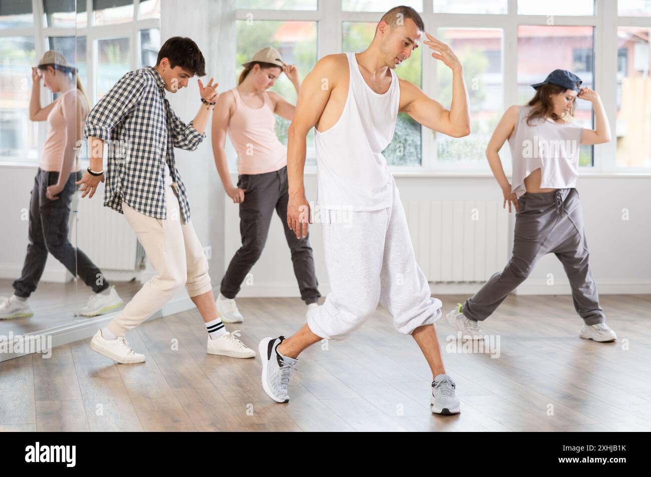 Young guy practicing hip hop slide moves in training hall Stock Photo ...