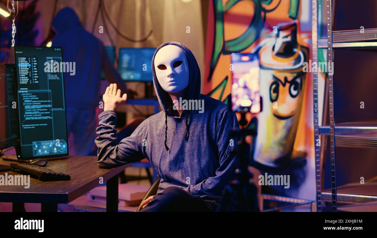 Masked hackers filming ransom video in hidden underground base, threatening to release stolen ...