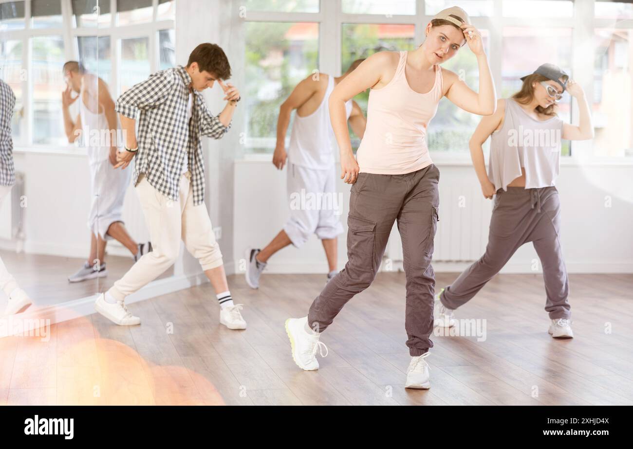 Group of young people perform choreographic exercises and teaches ...