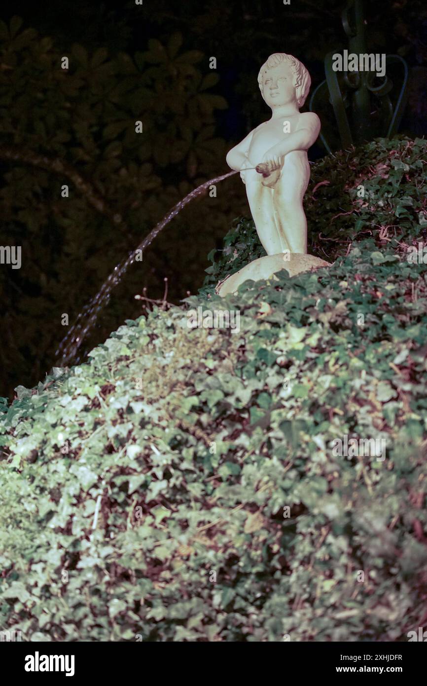 Stone statue of a child urinating in a garden in the Alentejo town of ...