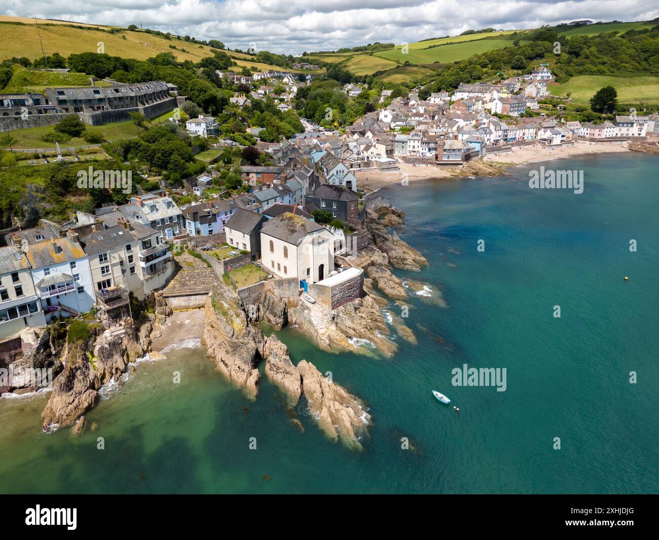 Aerial view of a coastal village with houses on cliffs and a beach ...