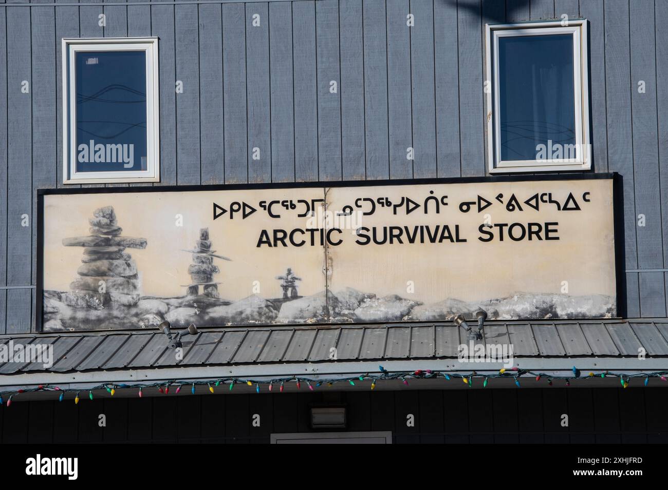 Bilingual Arctic Survival Store sign in English and Inuktitut on Nipisa ...