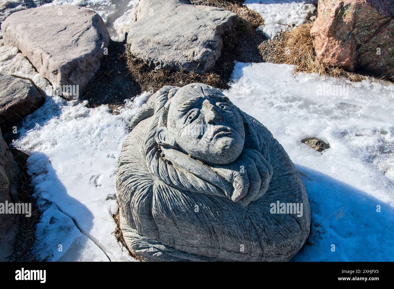 Stone carving of rope and face at Inuit sculpture park by the Four ...