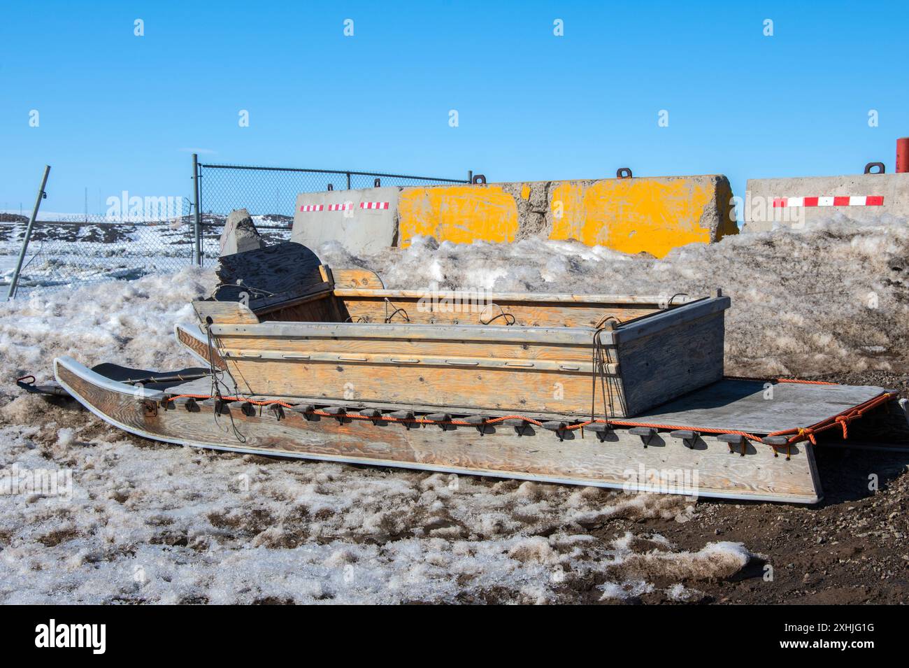 Inuit qamutiik wooden sleds stored on the beach on Frobisher Bay in ...