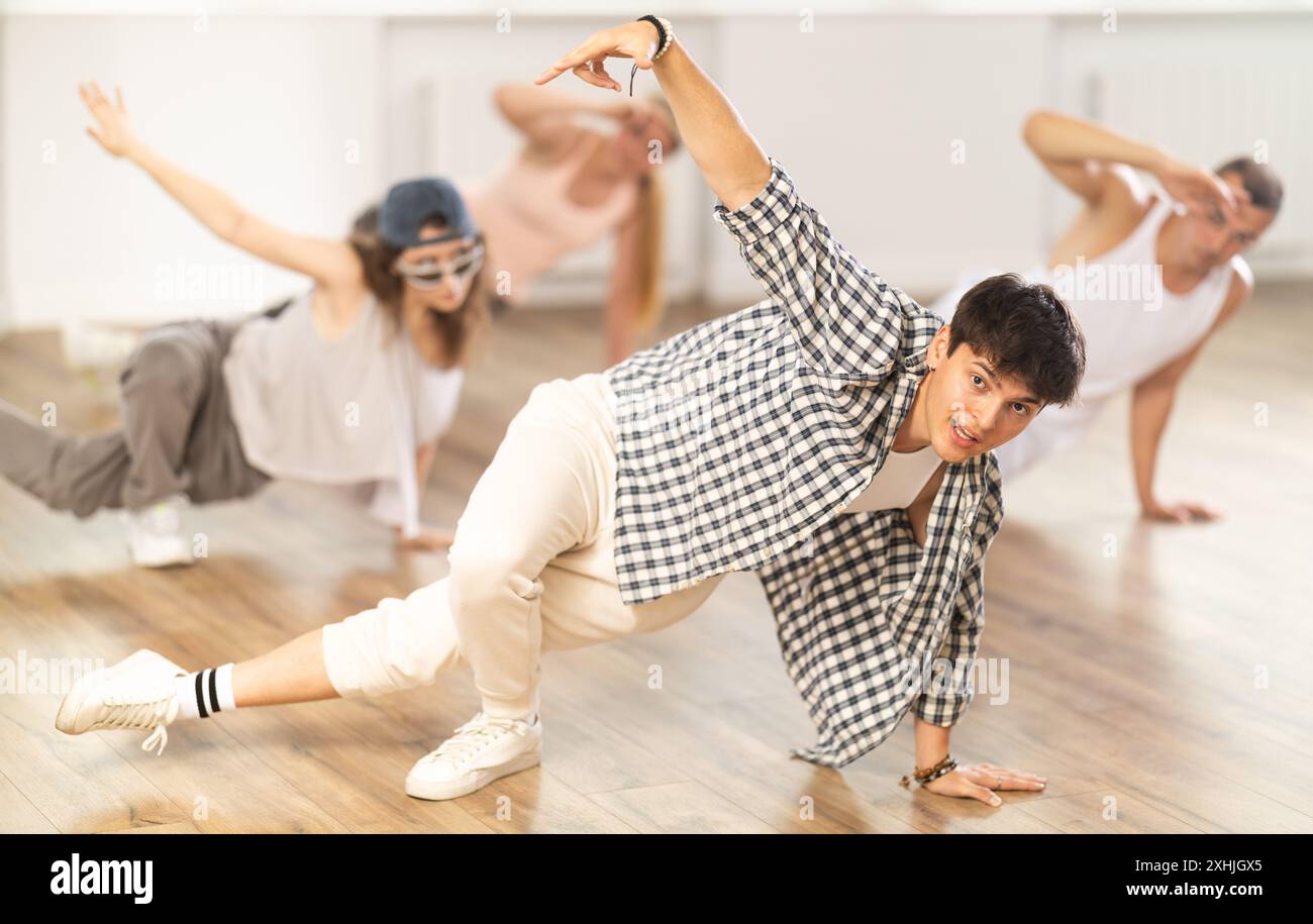 Group of young friends learn group dances - hip-hop and breakdance in ...