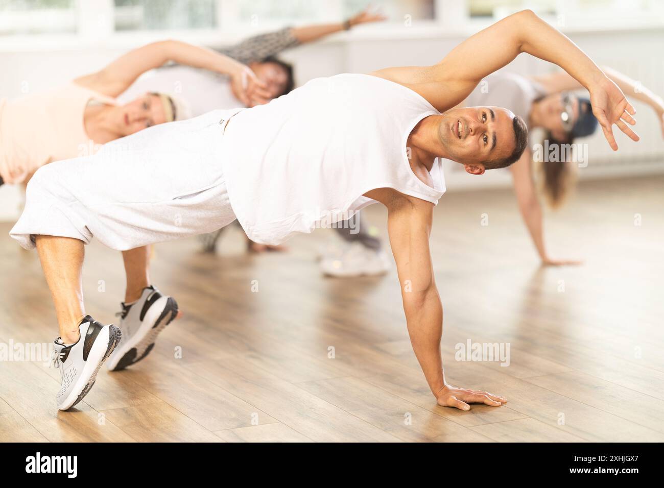 Young guy practicing breakdance in training hall Stock Photo - Alamy