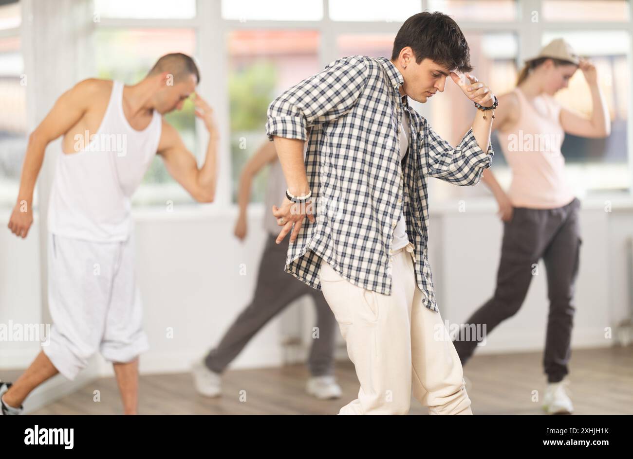 Young guy practicing hip hop slide moves in training hall Stock Photo ...