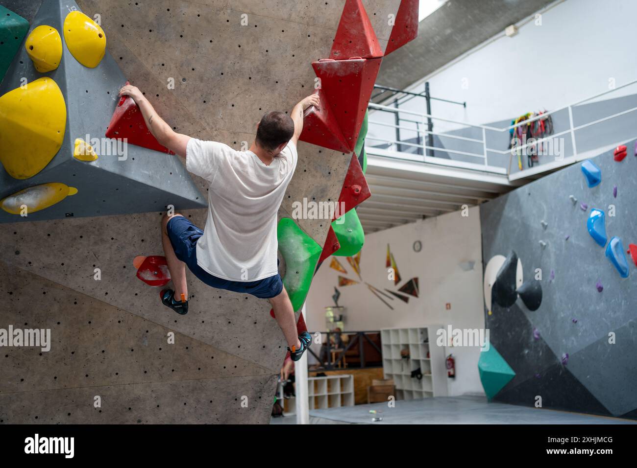 Determined man climbing exercise mountain at gym. Back view of adult ...