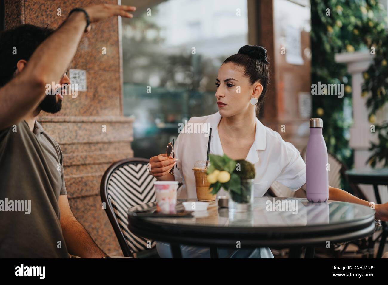 Business partners discussing new project in a modern coffee shop ...