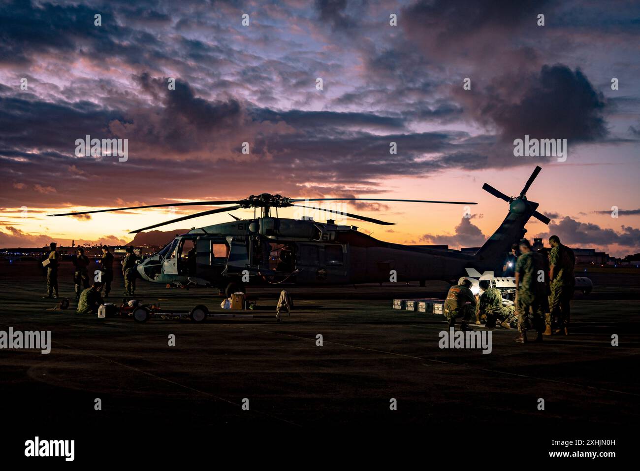 U.S. Navy Aviation Ordnancemen prepare to load a MH-60S Seahawk with an ...