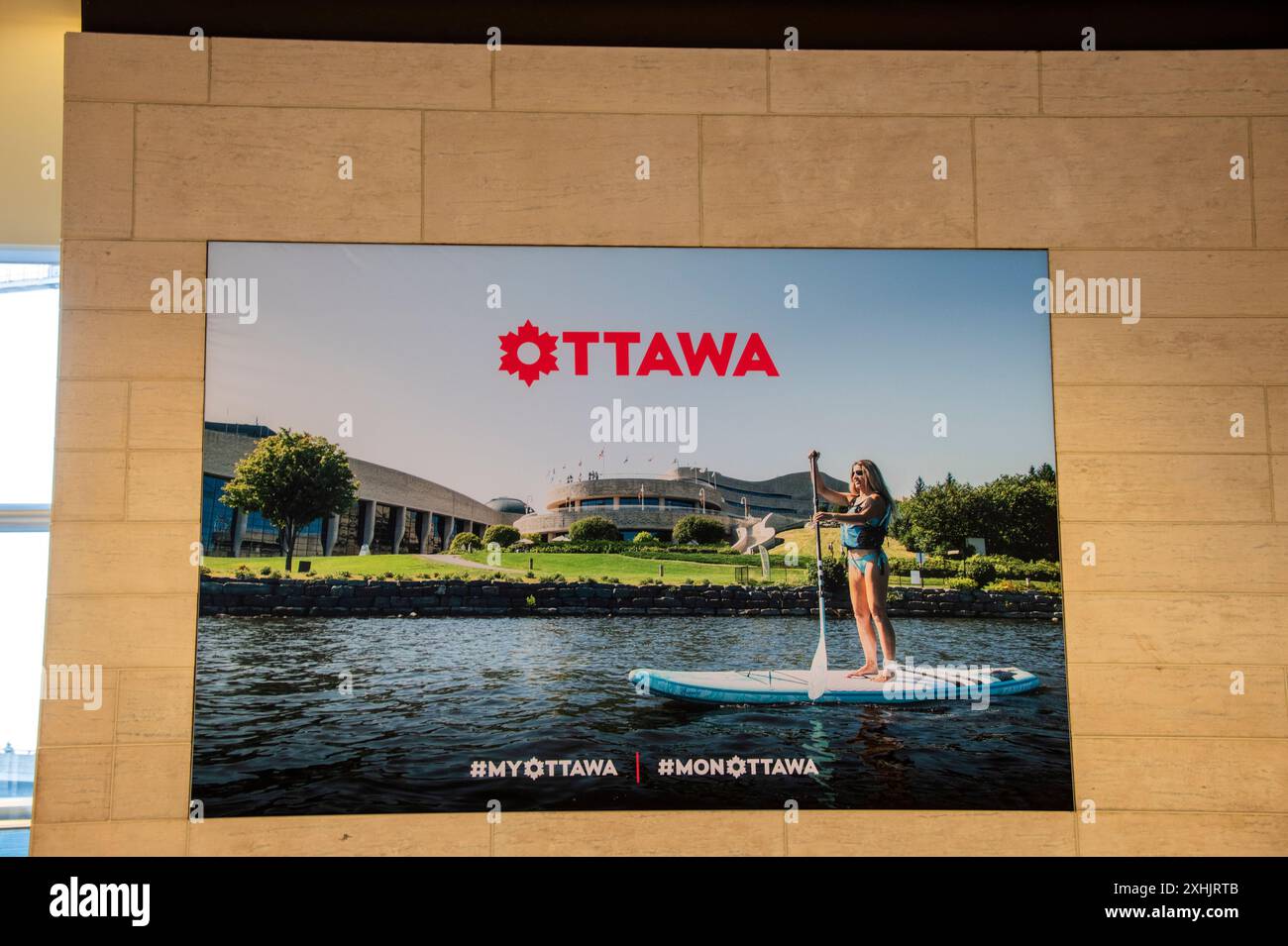 My Ottawa sign with a woman paddle boarding on the river at the Ottawa ...