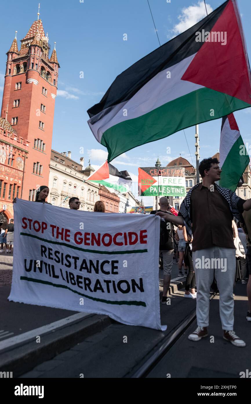Palestine supporters hold a banner and flags during the rally. Dozens ...