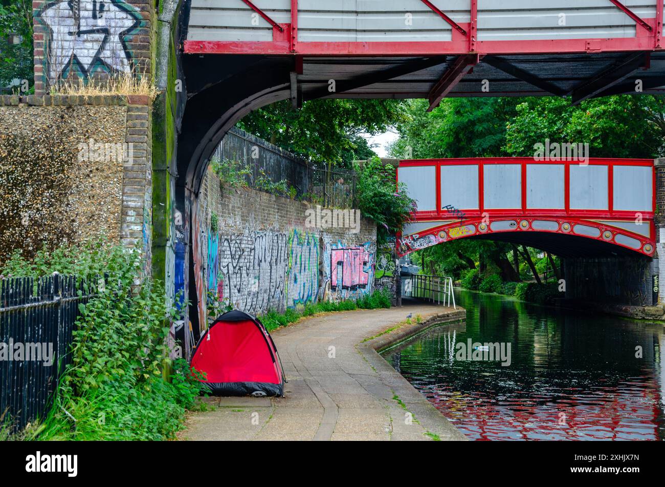 A tent pitched by a homeless person underneath a bridge spanning The ...