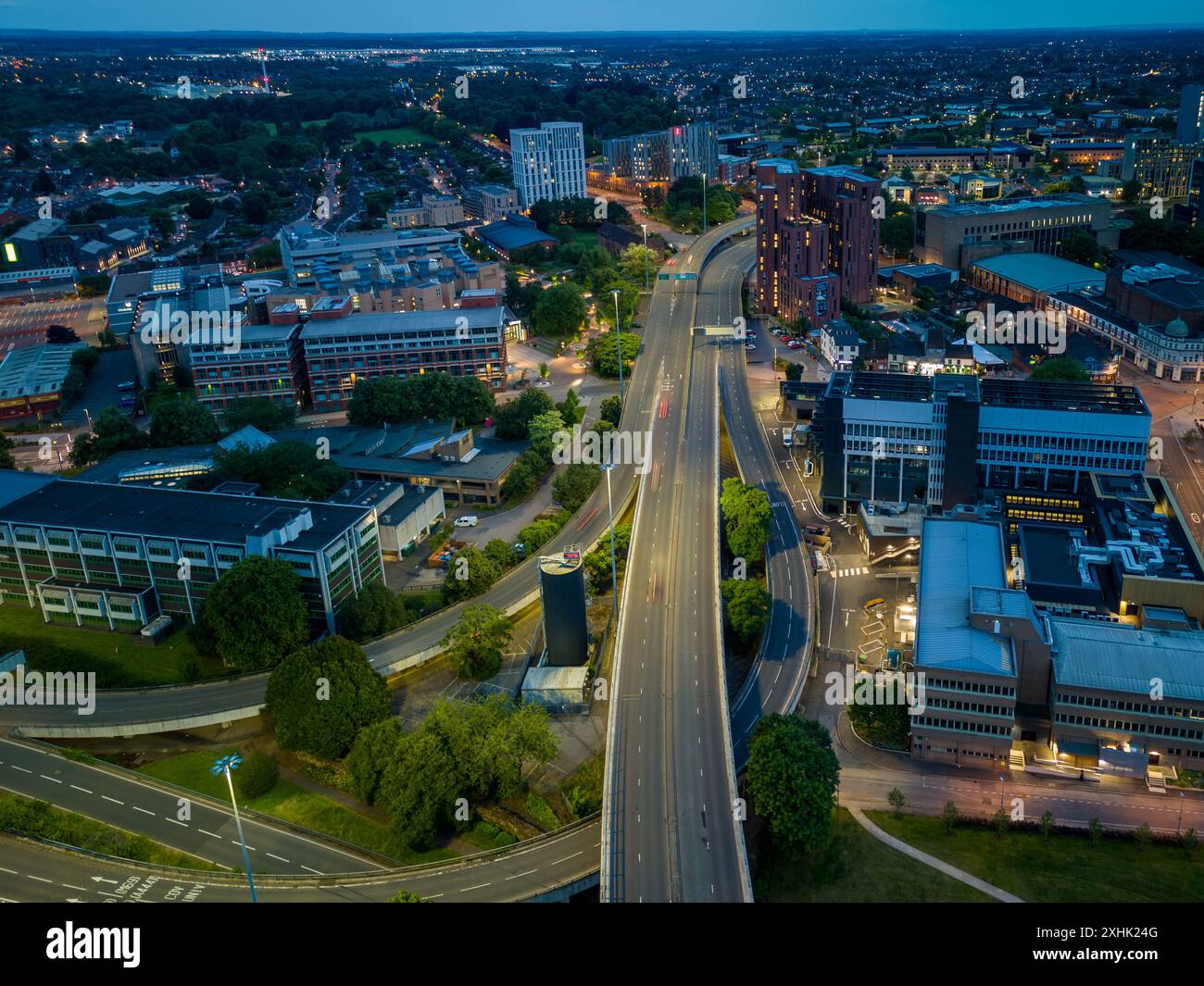 Cars driving on highway through city center at twilight Stock Photo - Alamy