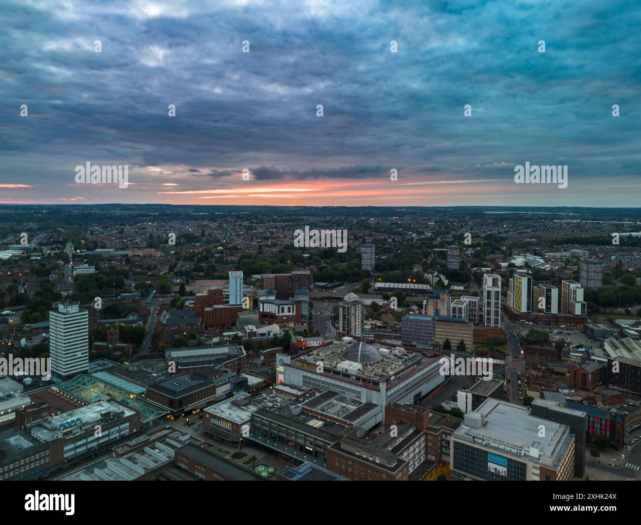 Aerial view of coventry city center at dusk, showing a dramatic sunset ...
