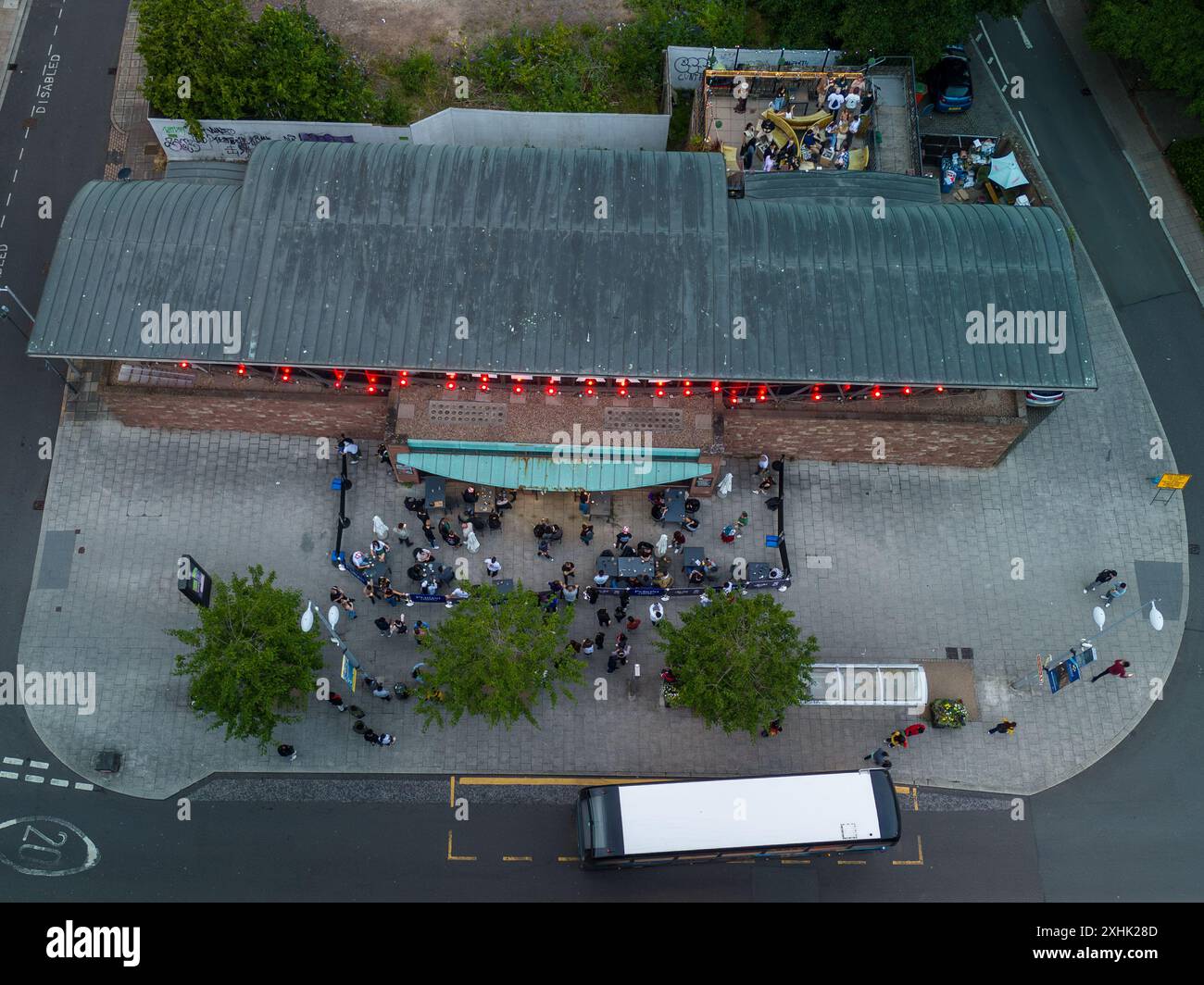 Aerial view of a busy city center bar at dusk, with customers enjoying ...