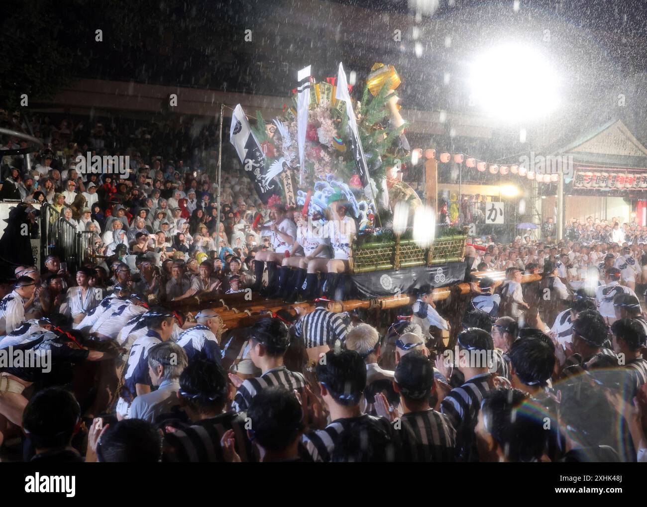 In Heavy Rain Participants Carrying The Yamakasa Float Arrive At