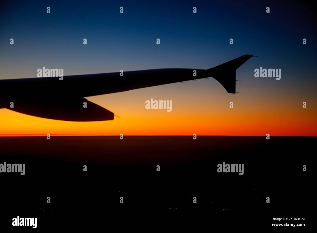 Airplane Wing and the colors of Sunset or Sunrise in the horizon Stock ...