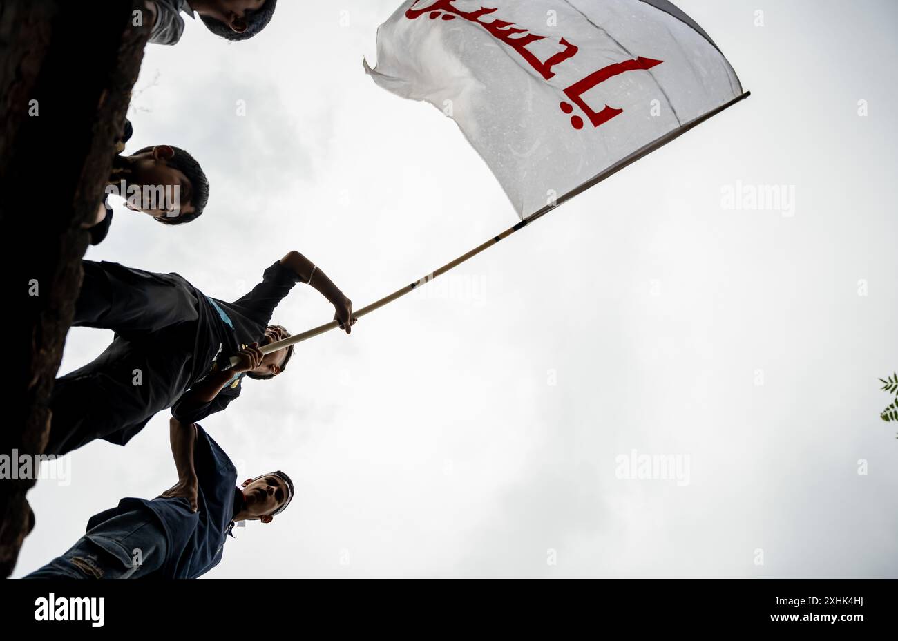 Srinagar, India. 14th July, 2024. A Kashmiri Shia Muslim man waves a ...