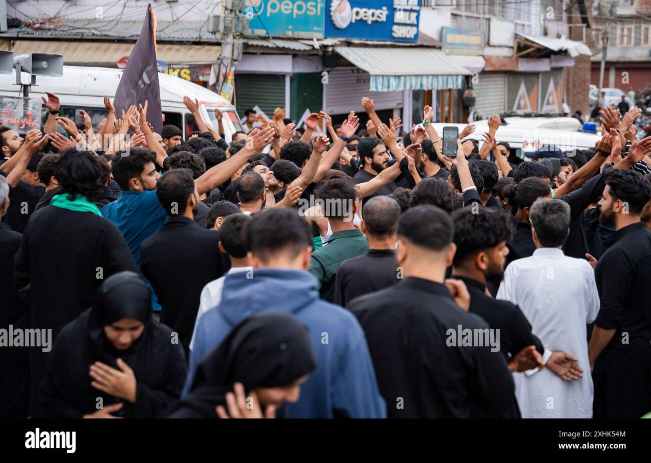 Srinagar, India. 14th July, 2024. Shia Muslims beat their chests and ...