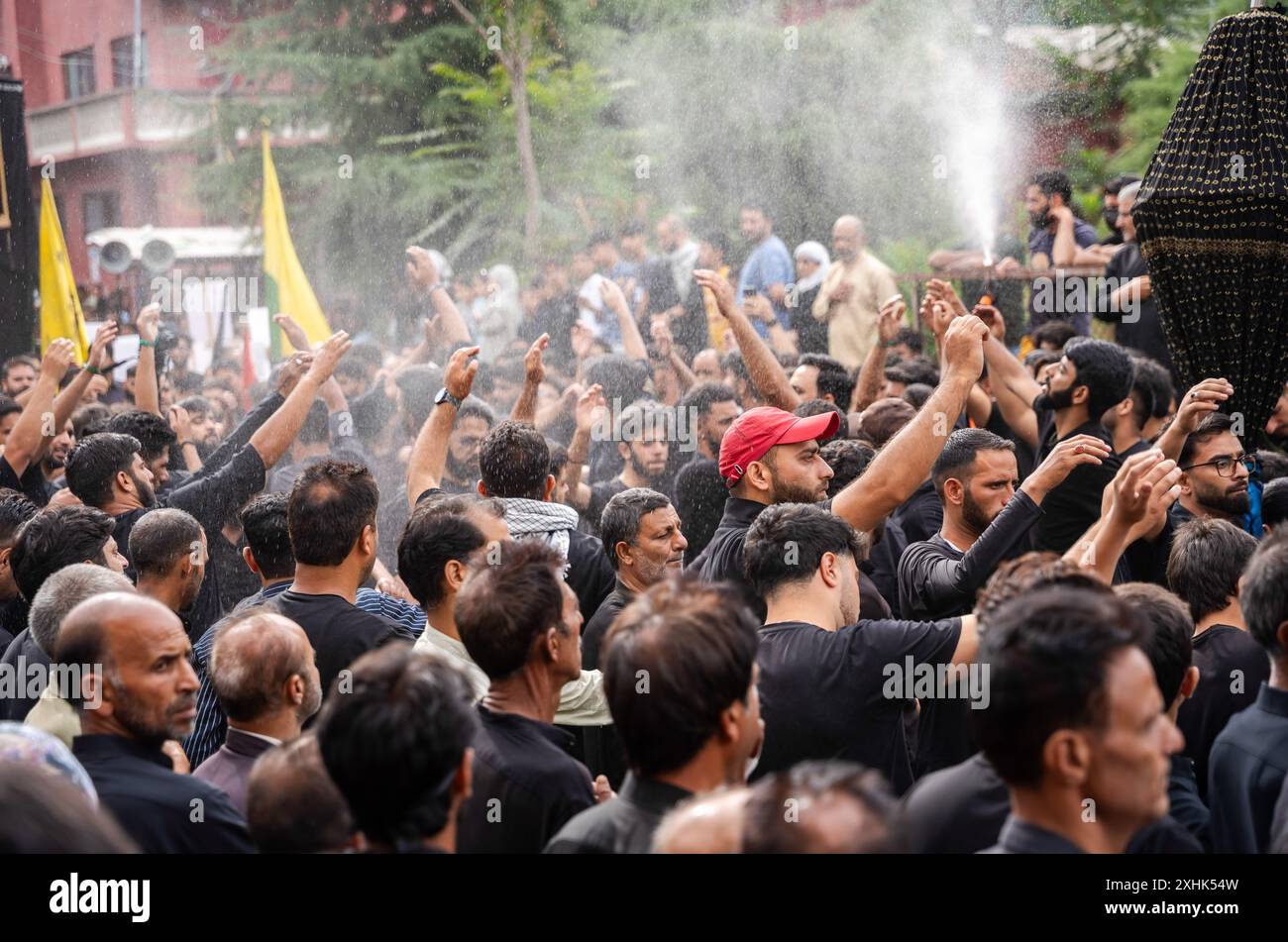 Srinagar, India. 14th July, 2024. Shia Muslims beat their chests and ...