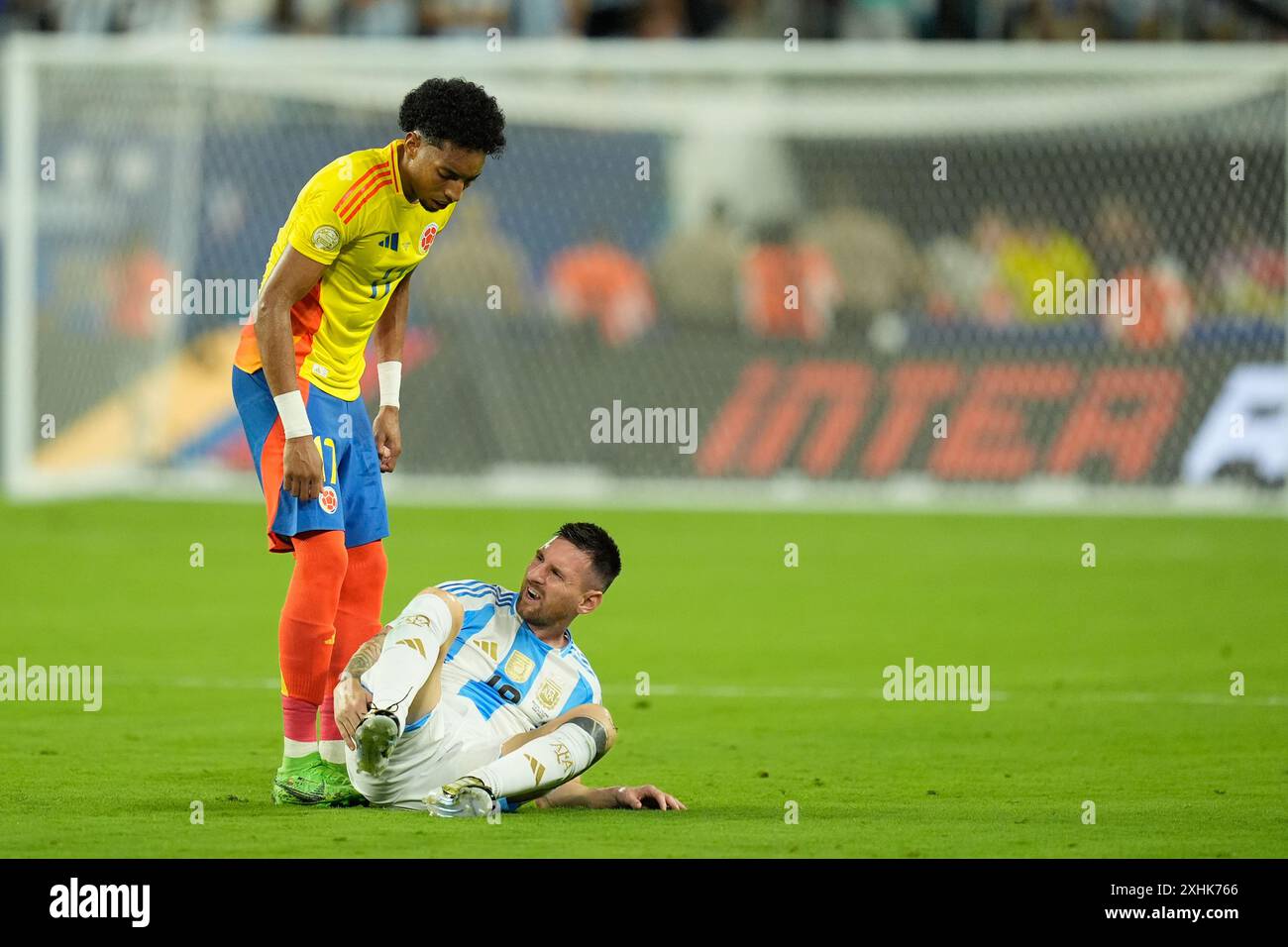Argentina's Lionel Messi grimaces in pain as Colombia's Johan Mojica ...