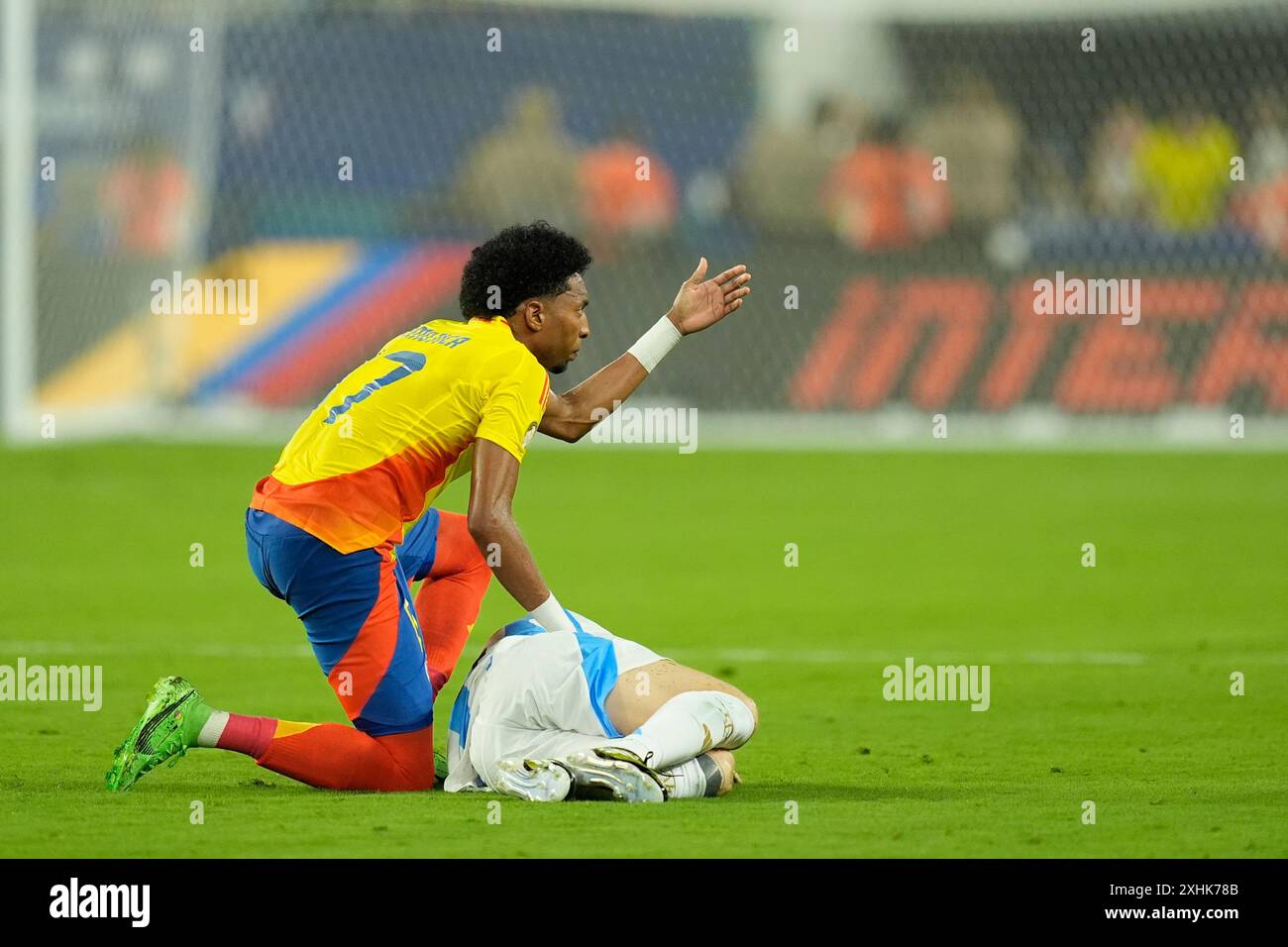 Argentina's Lionel Messi grimaces in pain as Colombia's Johan Mojica ...