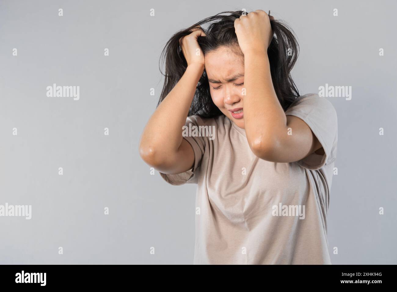 Young asian beautiful woman hand touching head she's feeling depressed ...