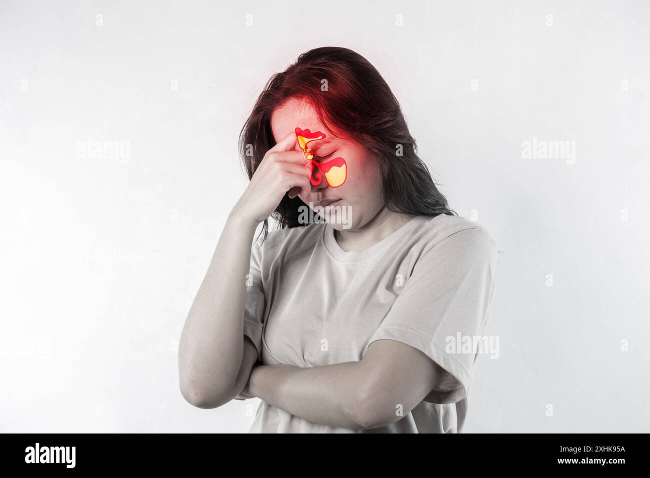 A woman with a red nose and red eyes. She has her hands on her head ...