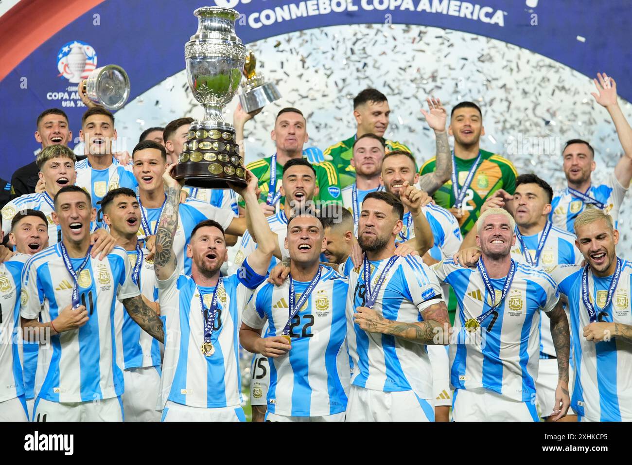 Argentina's Lionel Messi holds the trophy while celebrating with ...