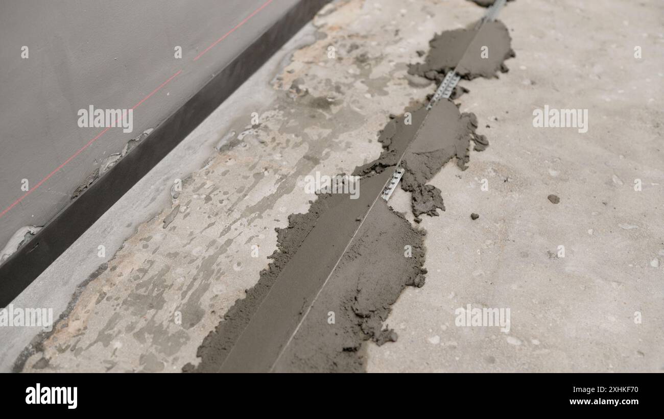 Construction work using ceramic floor tiles. Floor renovation concept ...