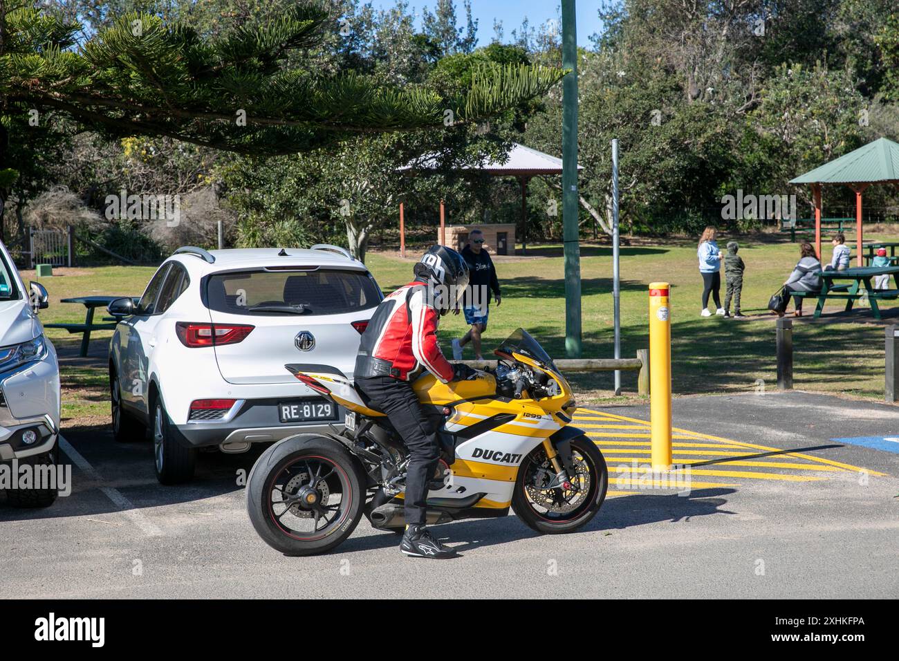 Yellow Ducati Panigale S 1299cc sports bike with rider at Palm Beach ...