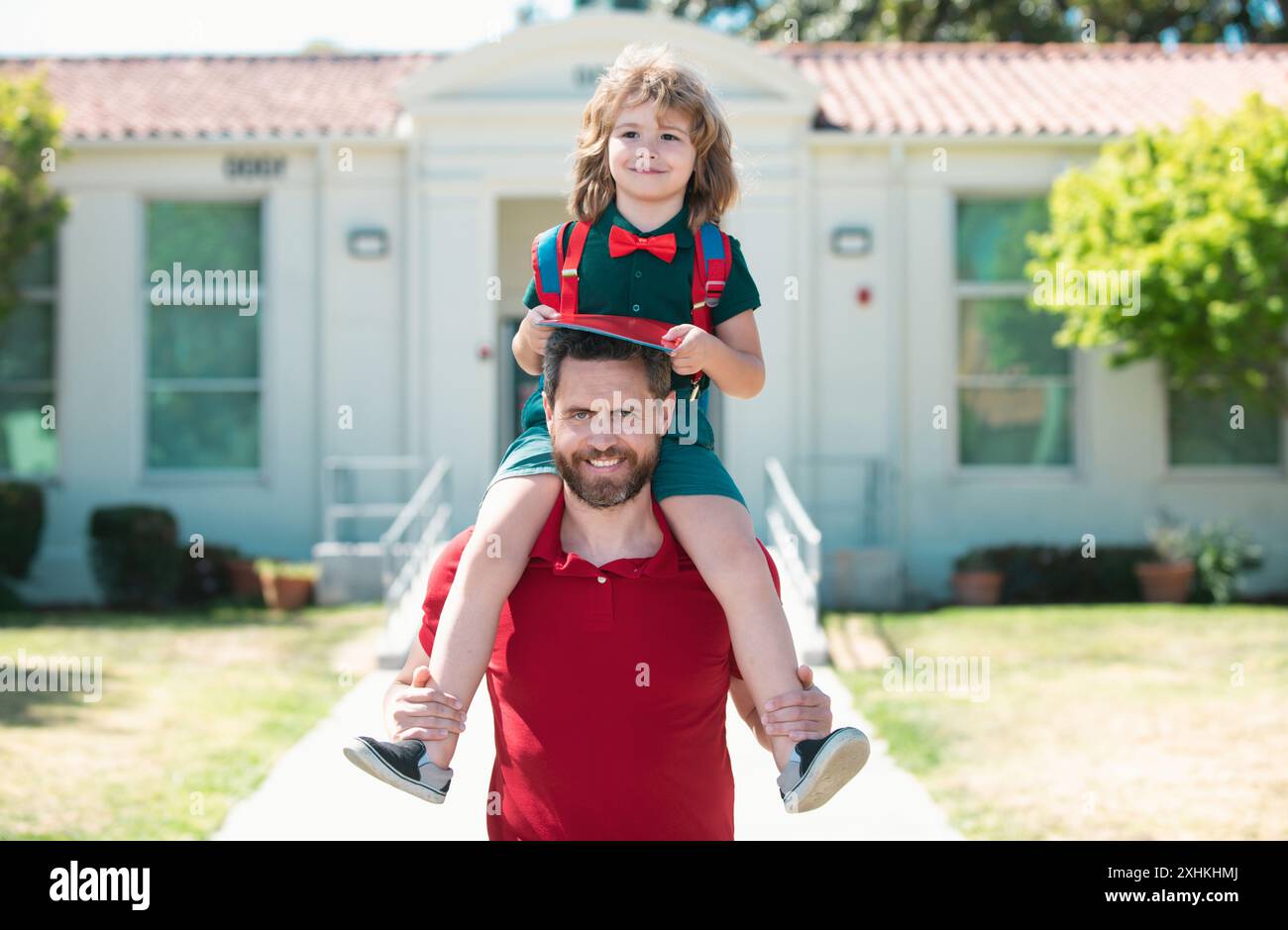 Father get a son pupil piggyback ride after study school. Family ...