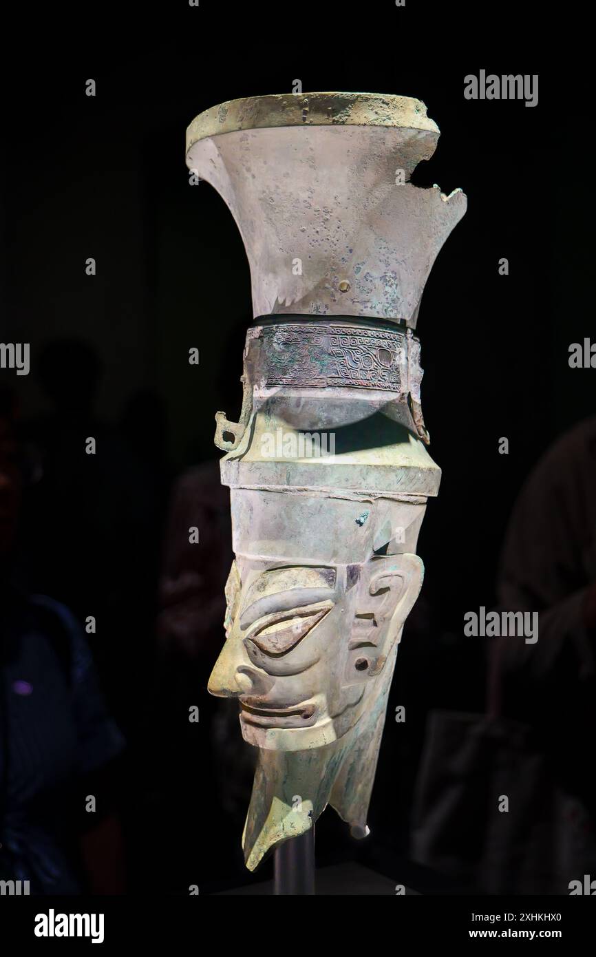 Guanghan China - May 24 2024: A Bronze head statue with ritual vessel ...