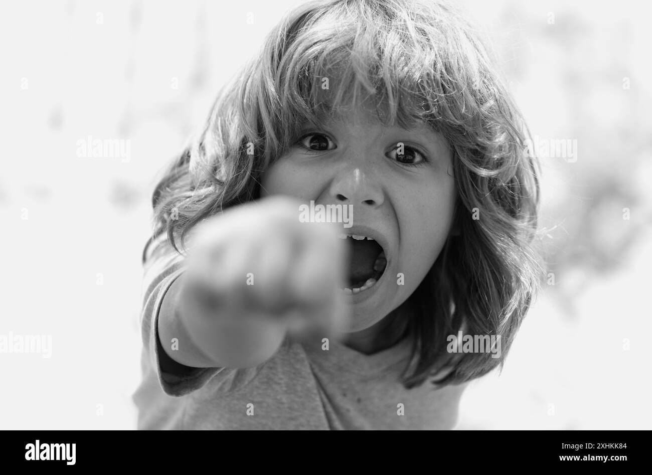 Enraged kid boy with angry expression. Angry hateful little rage boy ...