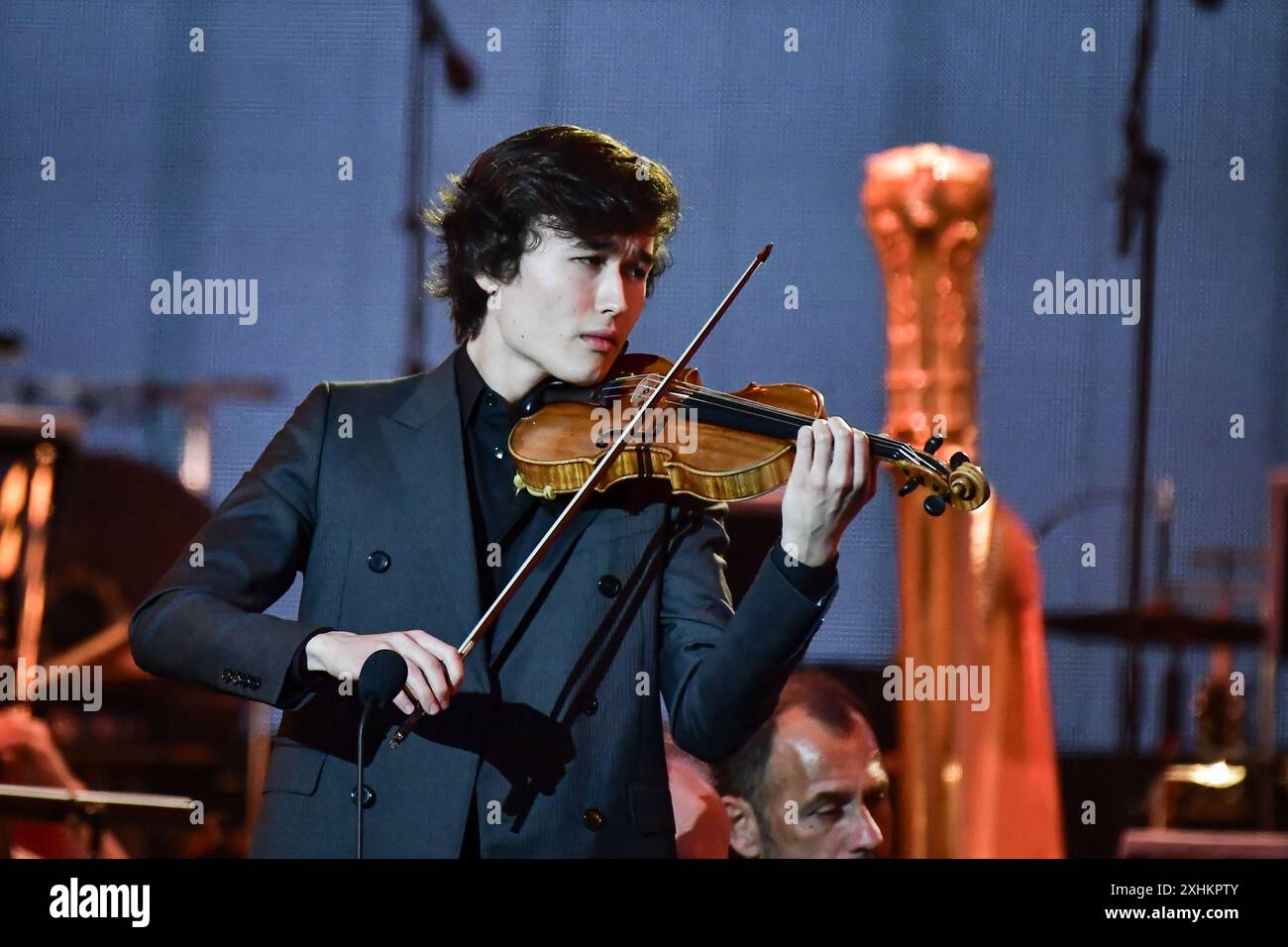 Swedish violinist Daniel Lozakovich performs before the arrival of the Olympic flame during the ...