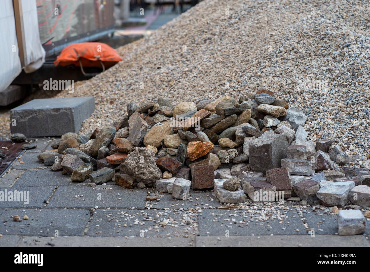 A mountain of rubble and the remains of old paving stones at a ...
