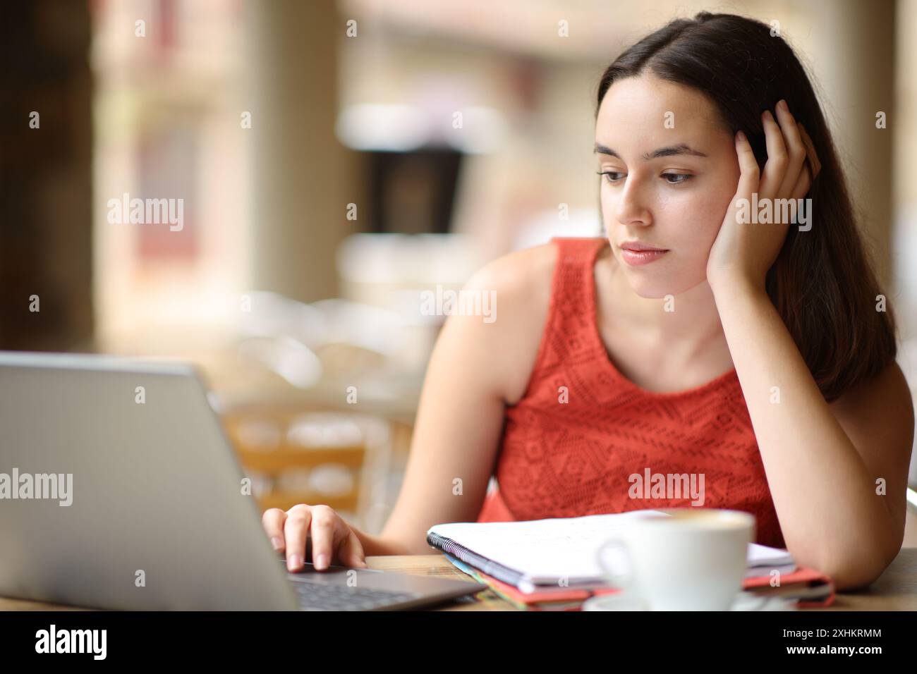 Student e-learning using computer sitting in a coffee shop Stock Photo ...