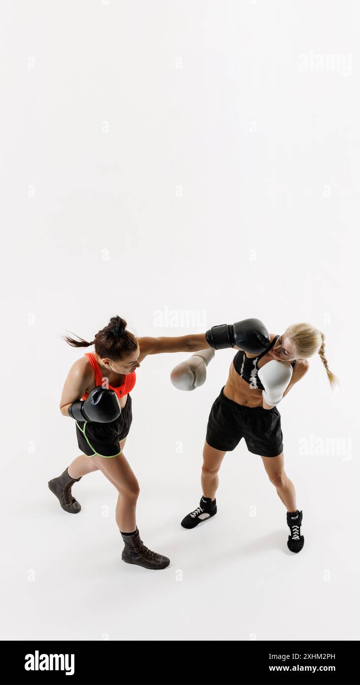 Vertical top view image of two competitive women, boxing athletes ...
