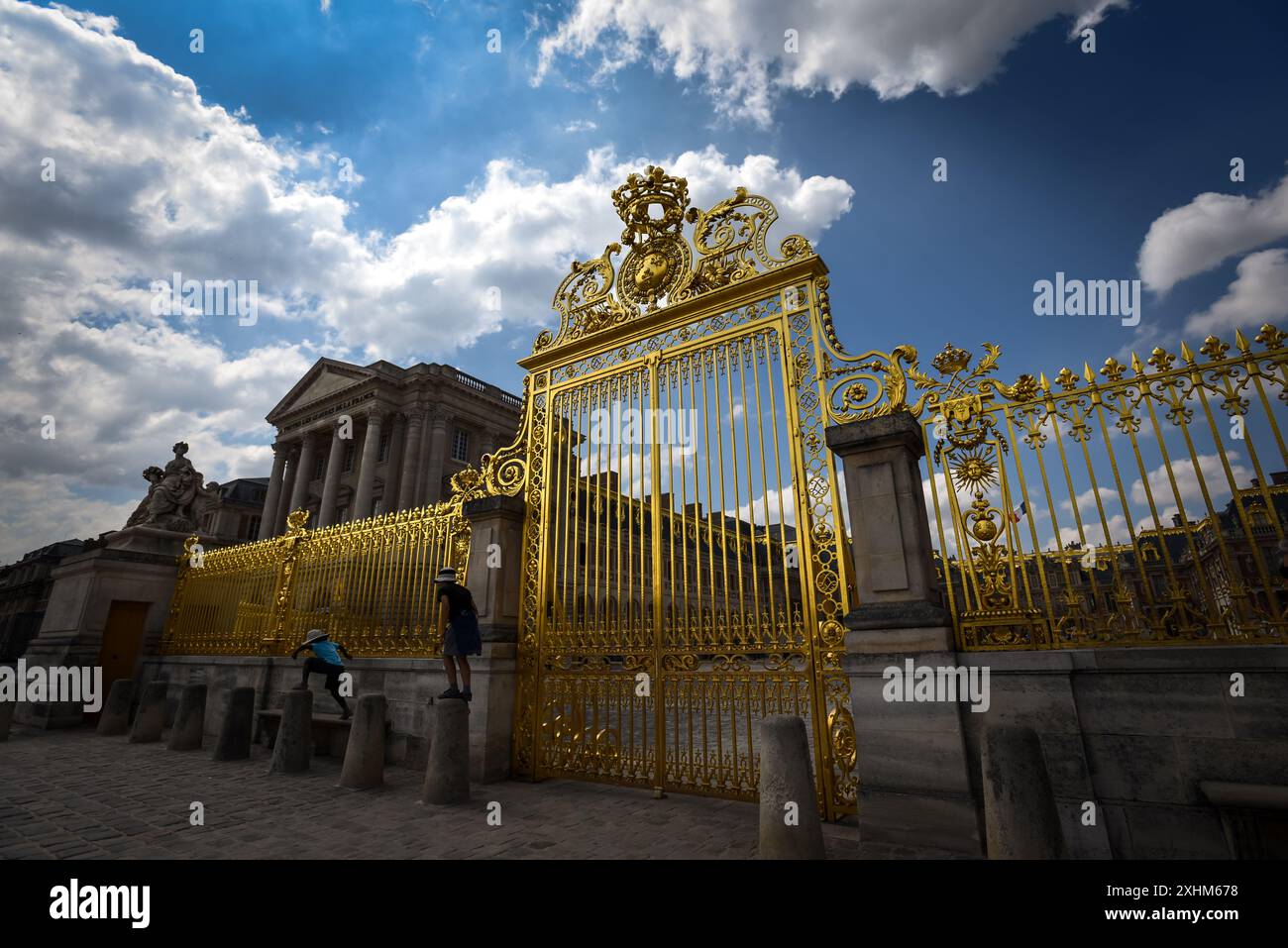 The Ornate Golden Gates of Versailles Palace with Playful Children ...