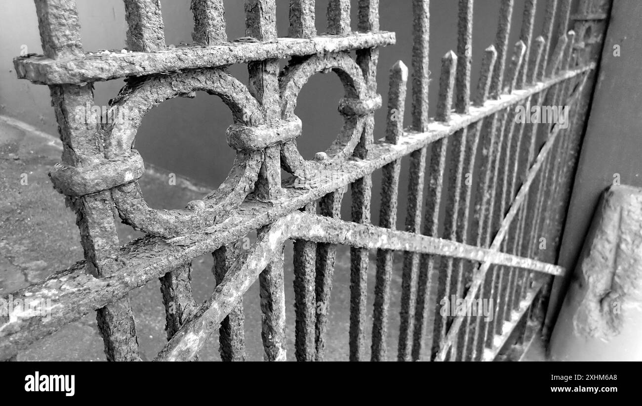 A rusty big old iron gate in a city lane Stock Photo - Alamy