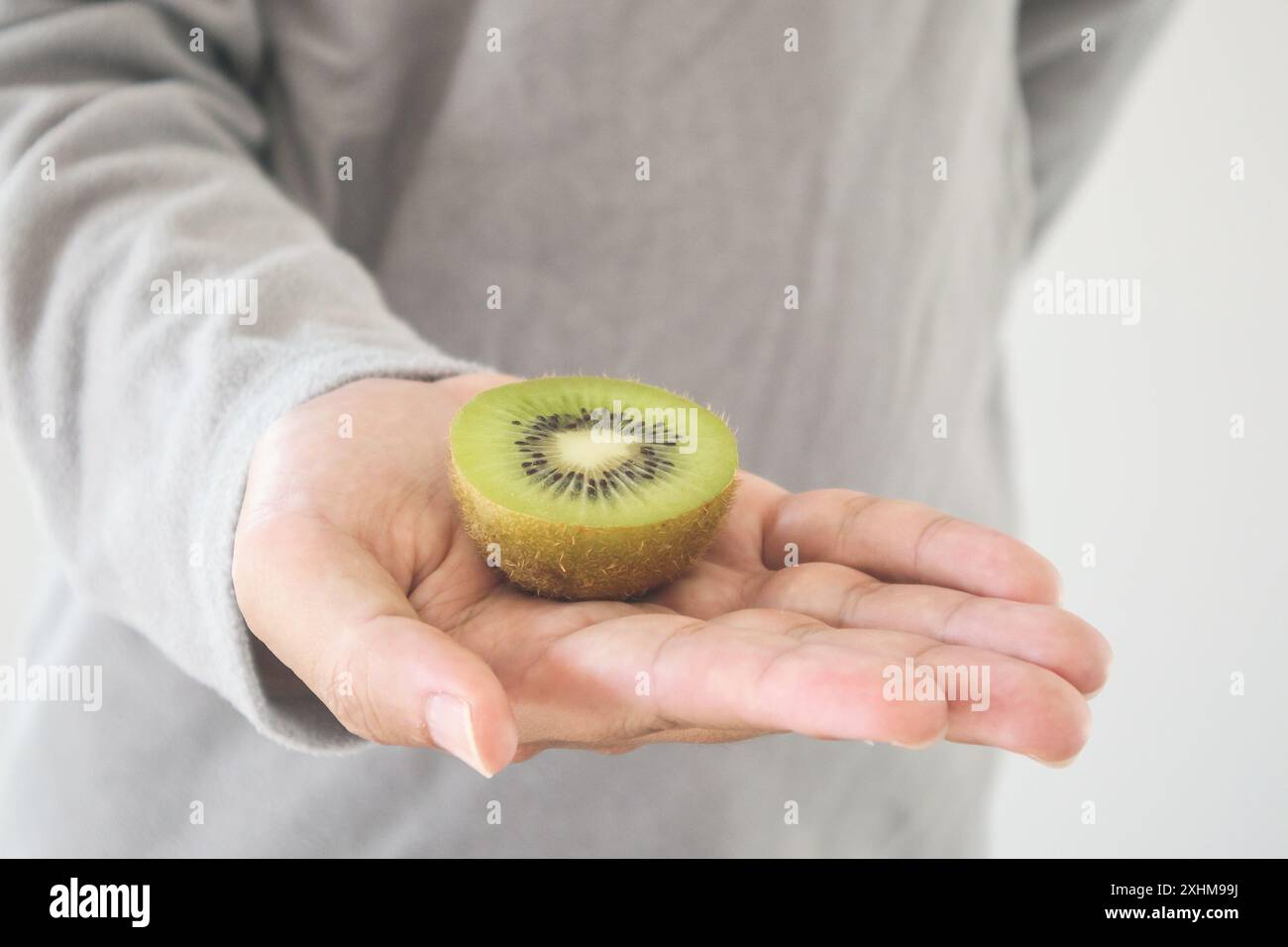Woman holding fresh kiwi hands hi-res stock photography and images - Alamy
