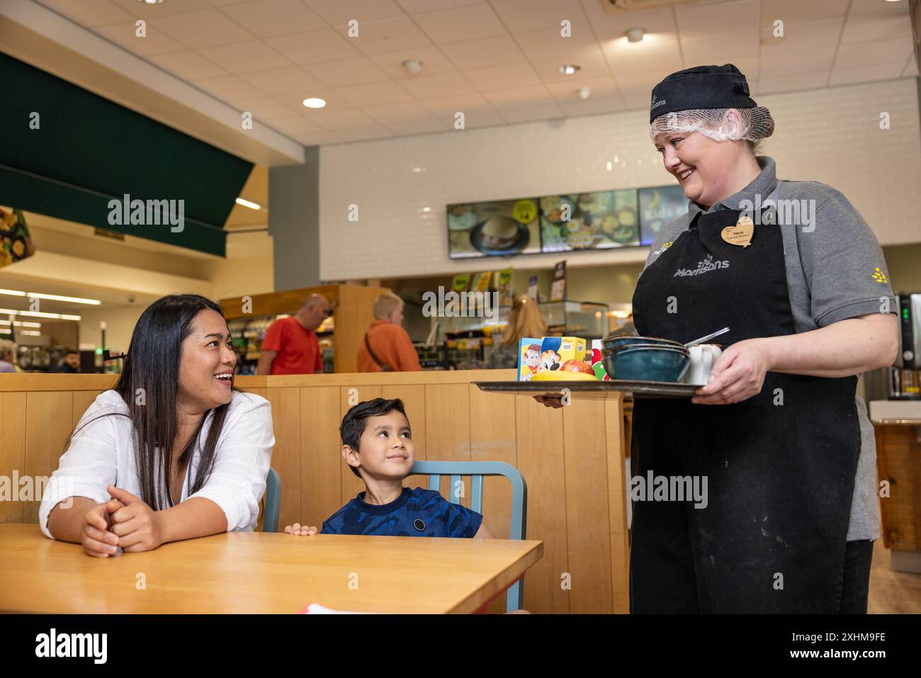EDITORIAL USE ONLY Customer assistant Marie (right), and Ratcha and Jacob help launch a joint ...