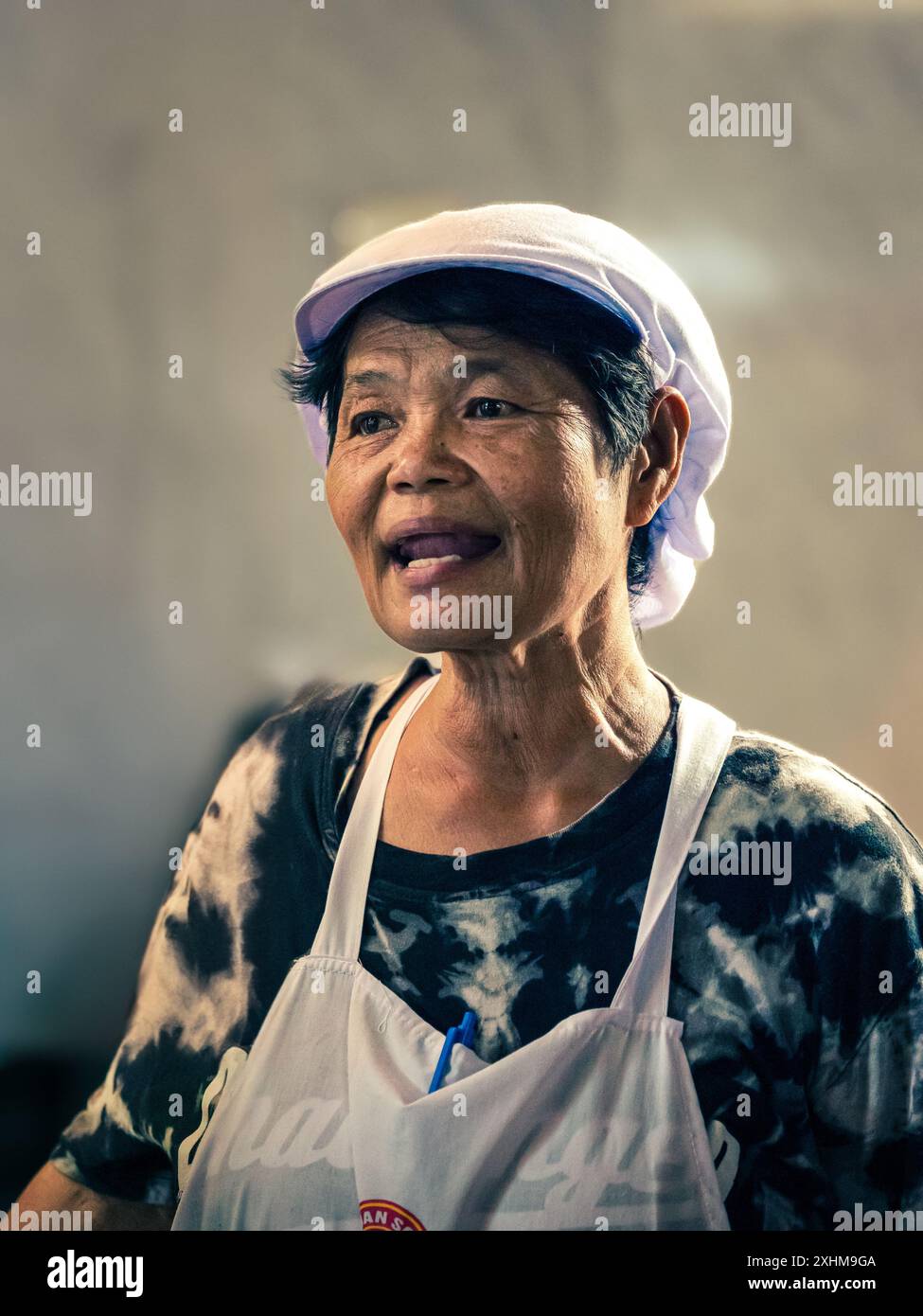 Older Woman Wearing White Apron and Hat in a Southeast Asian Kitchen ...